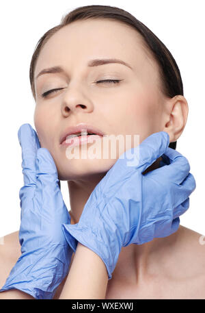 Beautician touch and exam health woman face. Plastic surgery. Isolated ...