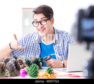 Young vlogger recording video doing christmas decoration Stock Photo ...