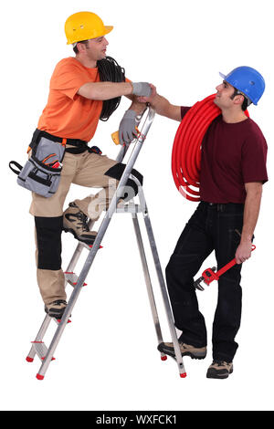 Two electrician with step ladder Stock Photo - Alamy