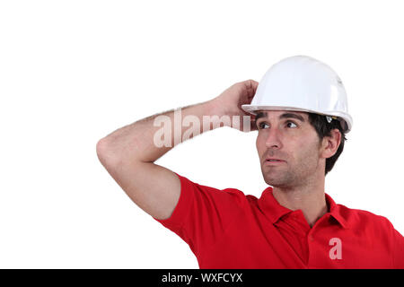 workman adjusting his hard hat to fit correctly Stock Photo - Alamy