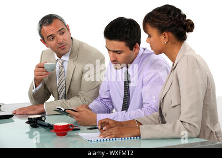 Three people sat on interview panel Stock Photo - Alamy
