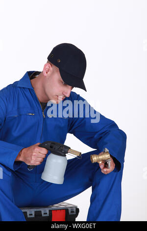 Plumber using a blow torch Stock Photo - Alamy