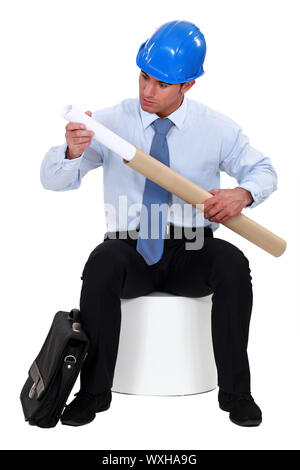 Engineer pulling a technical drawing out of its case Stock Photo - Alamy