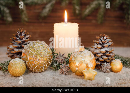 christmas baubles, burning candle and green pine fir prepared for ...