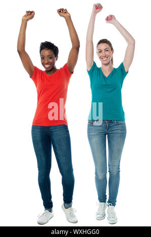 Excited friends celebrating raising arms on kayaks on summer vacation ...