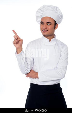 Young male chef pointing at something Stock Photo - Alamy