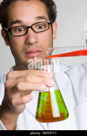 African American male chemist pouring blue liquid from plastic canister ...