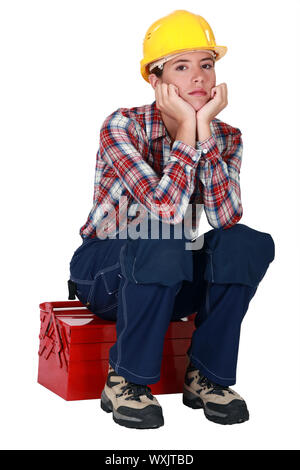 Builder sat on tool box thinking Stock Photo - Alamy