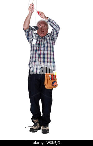 Electrocuted man fixing a light fixture Stock Photo - Alamy