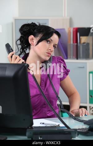 Stressed receptionist taking several calls at once Stock Photo - Alamy