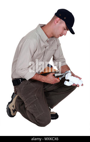 Male plumber with pipe on brown background Stock Photo - Alamy