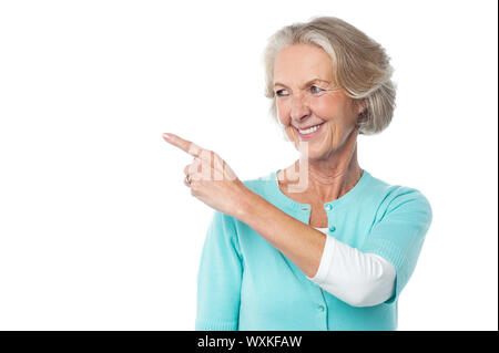 Lady pointing towards copy space area Stock Photo - Alamy