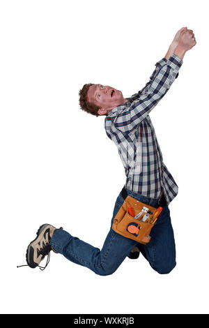 Exhausted man pulling an invisible object Stock Photo - Alamy