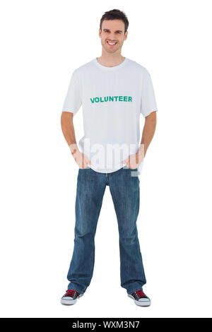 Young handsome man wearing volunteer t shirt using laptop making fish ...