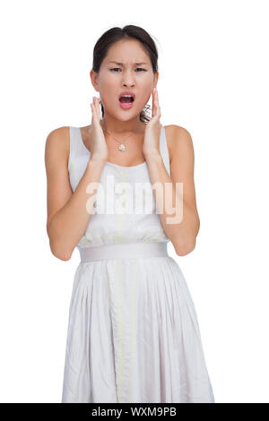 Revolted model posing against white background Stock Photo - Alamy