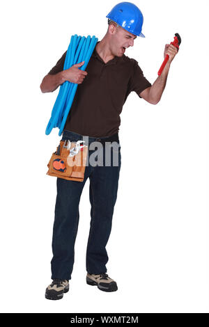 plumber looking angry Stock Photo - Alamy