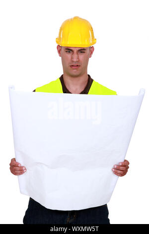 Confused construction worker trying to understand documents Stock Photo ...