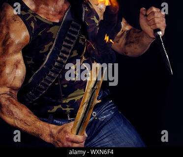 Body of muscular commando holding knife and torch Stock Photo - Alamy