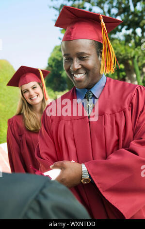 Graduate Shaking Hands and Receiving Diploma Stock Photo - Alamy