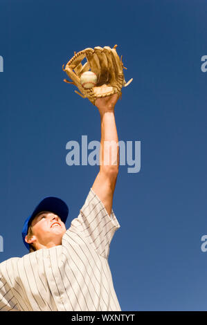 Sports, baseball and men jump to catch ball on field during game ...