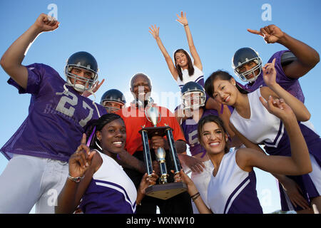 Cheerleaders and Football Players Celebrating with Coach Stock Photo ...
