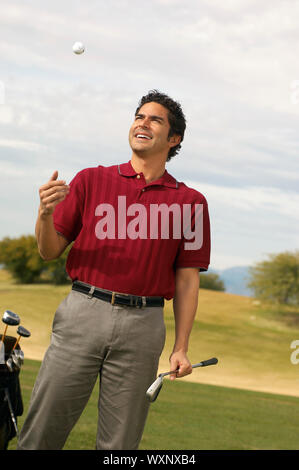 golfer tossing a ball Stock Photo - Alamy