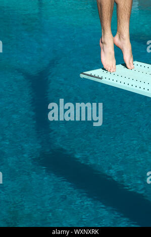 Male swimmer standing on diving board Stock Photo - Alamy