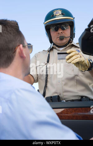 Police officer checking driver's ID Stock Photo - Alamy