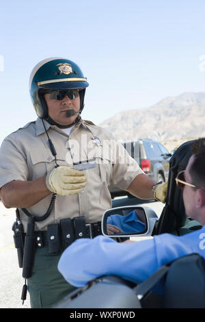 Police officer checking driver's ID Stock Photo - Alamy