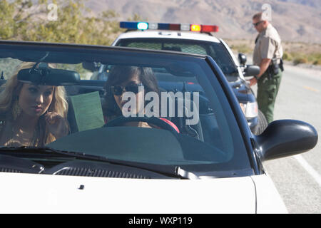 Two women reading speeding ticket in car Stock Photo - Alamy