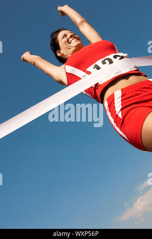 Runner Breaking Finish Line Tape Stock Photo - Alamy