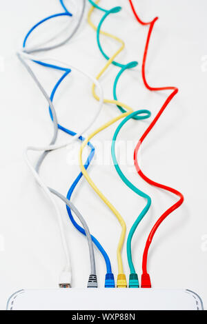Multi colored ethernet cables on a white background. Network equipment ...
