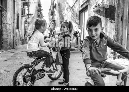 Kids playing on the streets of Palermo, a Sicilian city. November 2016 ...