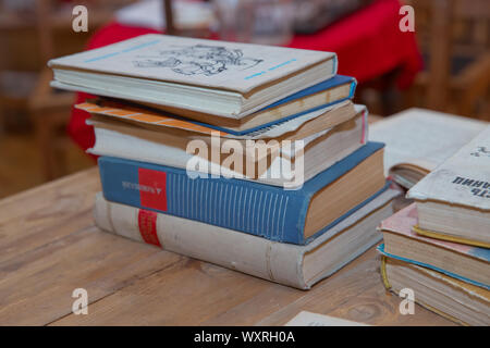 Standing books on a wooden table Stock Photo - Alamy