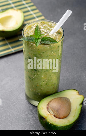 Whole avocado on dark background Stock Photo - Alamy