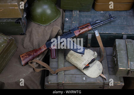 Kalashnikov AK 47 with ammunitions on army green box background. Text ...