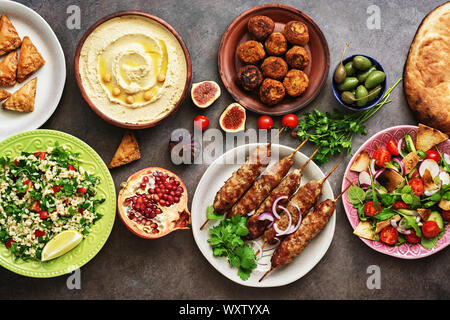 Middle eastern party food: falafel, babaghanoush, potatoes beef green ...