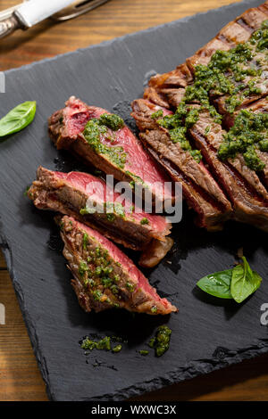 Prepared steak of beef with pesto sauce at plate Stock Photo - Alamy