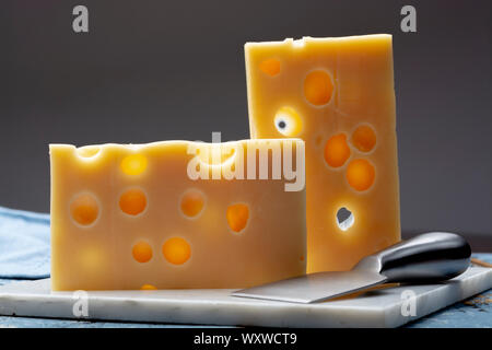 Two blocks of French emmental semi-hard cheese close up Stock Photo - Alamy