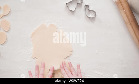 Step by step. Flat lay. Cutting sugar cookie dough with Easter shaped ...