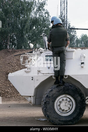 French United Nations Protection Forces clean a machine gun atop their ...