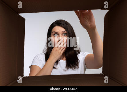 Shocked Lady Looking Inside Cardboard Moving Box Stock Photo - Alamy