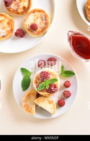 Sweet breakfast cheese pancakes or fritters Syrniki served with berries ...