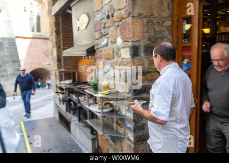 Preparing the fish in the grill in Asador Iribar restaurant in Getaria ...