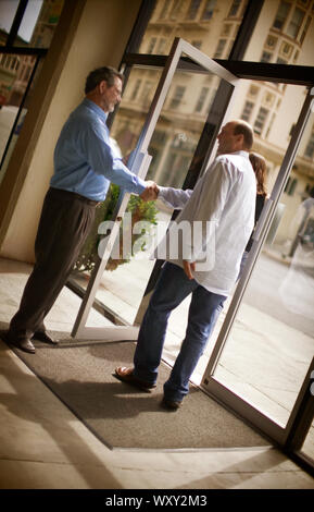 A man stands inside the door of his shop in Varzaneh, Iran Stock Photo ...