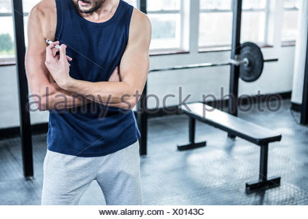 Muscle man injecting steroids into his strong arm using a syringe Stock ...
