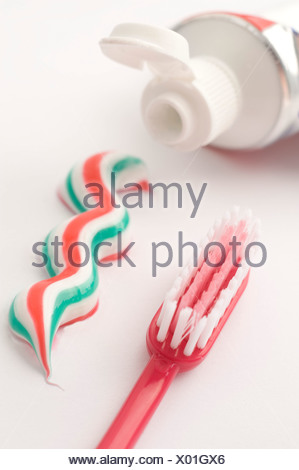 A crumpled tube of toothpaste, with white, green and red striped Stock ...