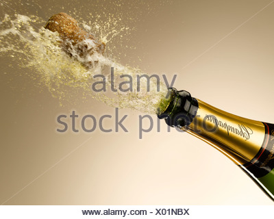 Cork exploding from champagne bottle wedding cake background Stock ...