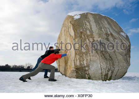 2 men pushing boulder Stock Photo: 24210437 - Alamy