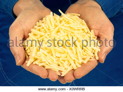 HANDFUL OF GRATED CHEDDAR CHEESE Stock Photo: 11310796 - Alamy